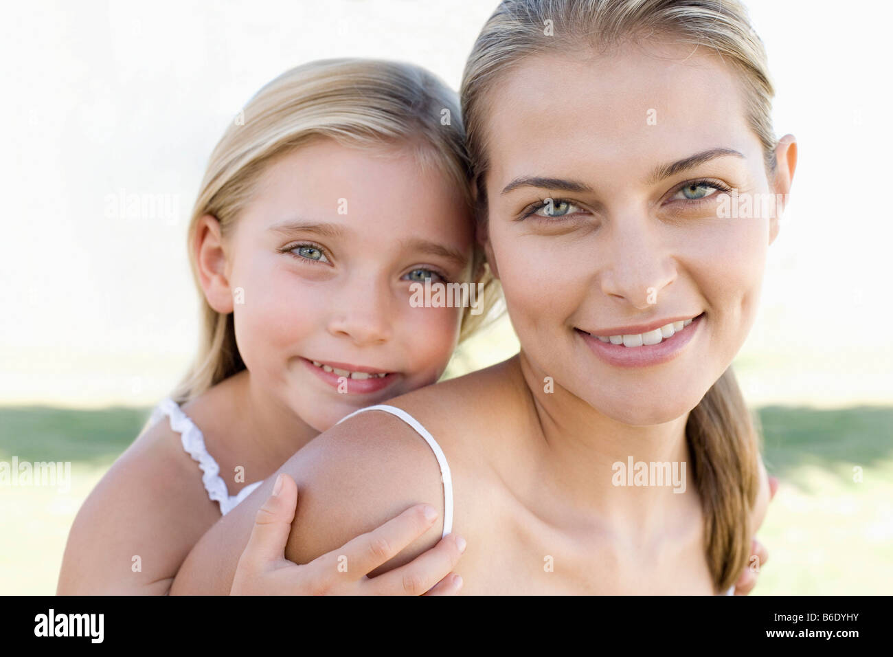 Mother carrying her daughter on her back Stock Photo - Alamy