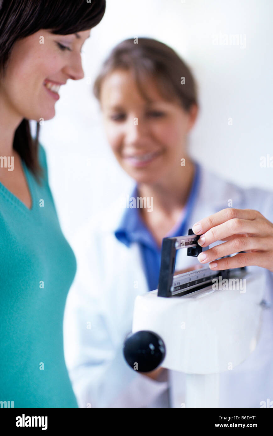 Weight check-up, General practice doctor adjusting the balance on ...