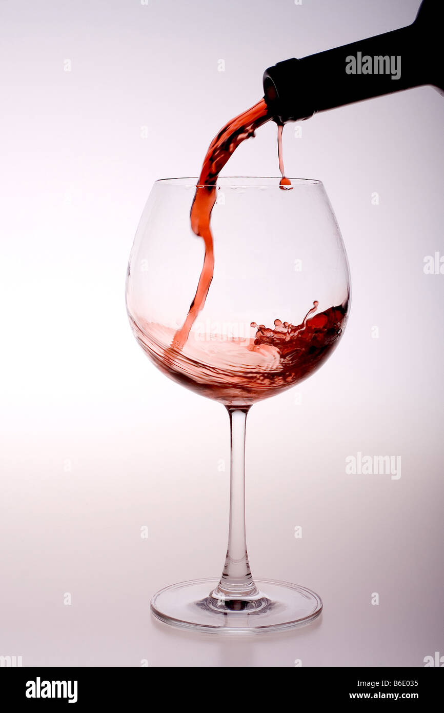 red wine flow in a transparent glass Stock Photo - Alamy