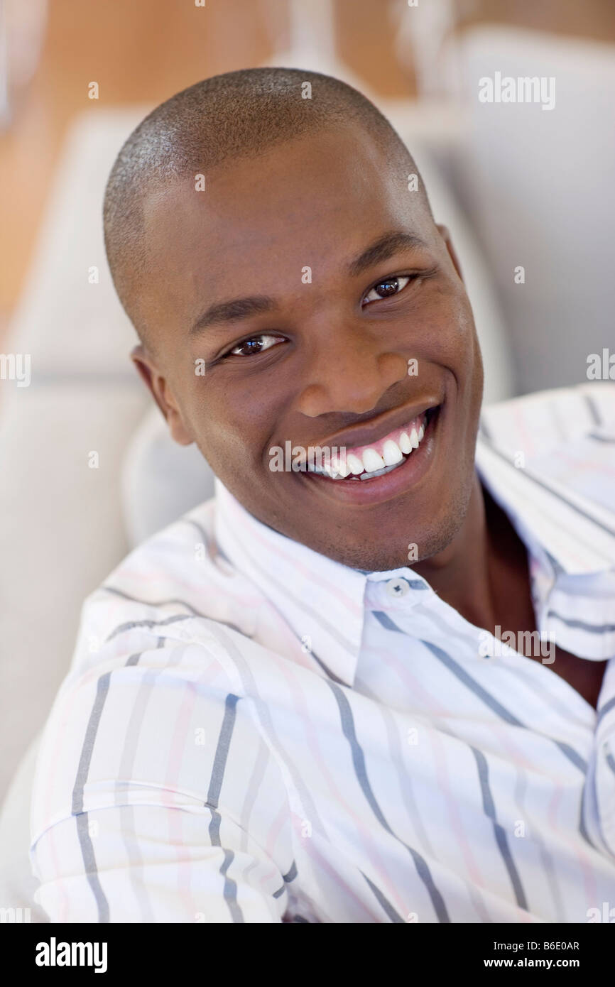 Happy man relaxing on a sofa Stock Photo - Alamy