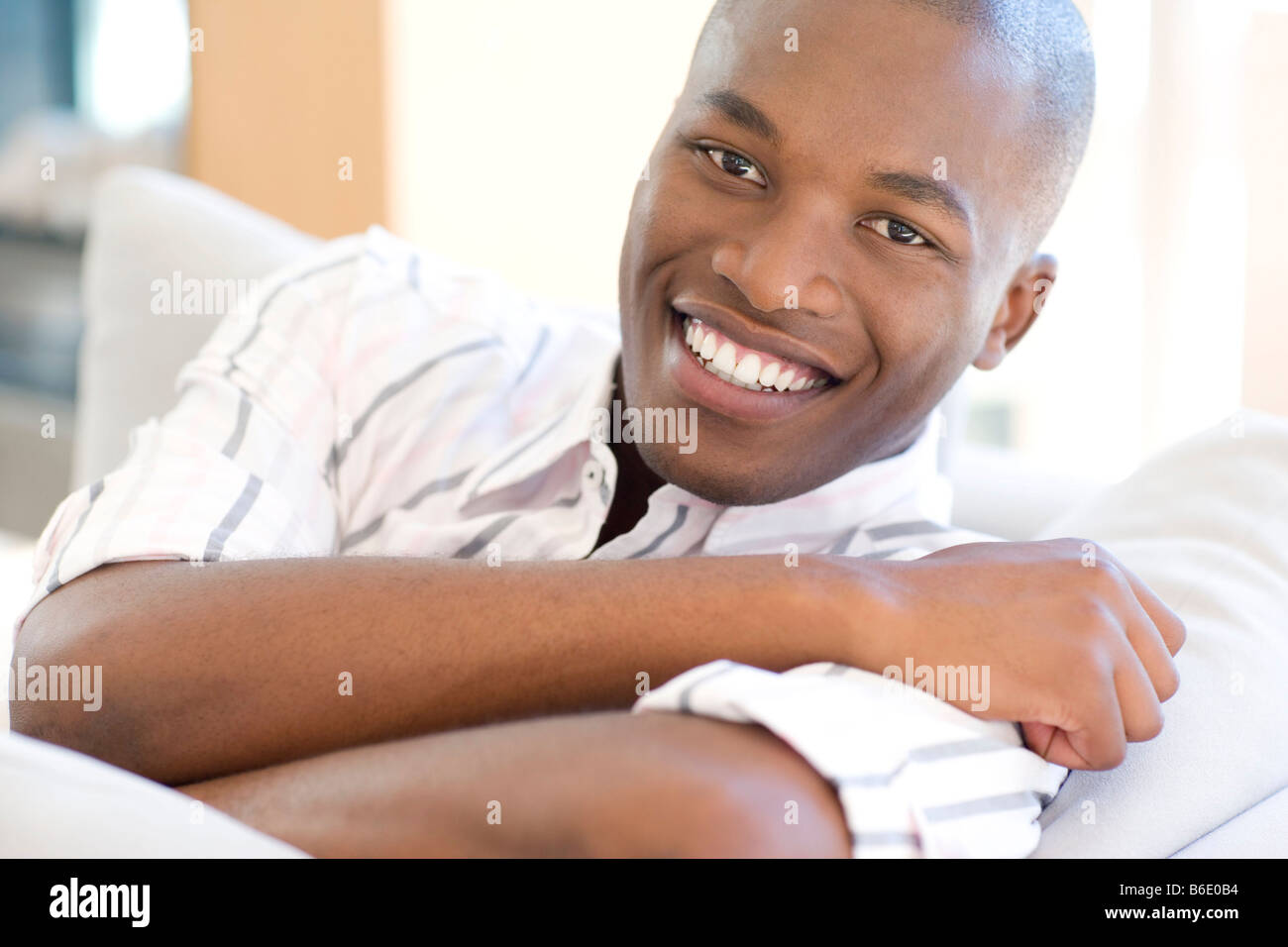 Happy man relaxing on a sofa Stock Photo - Alamy