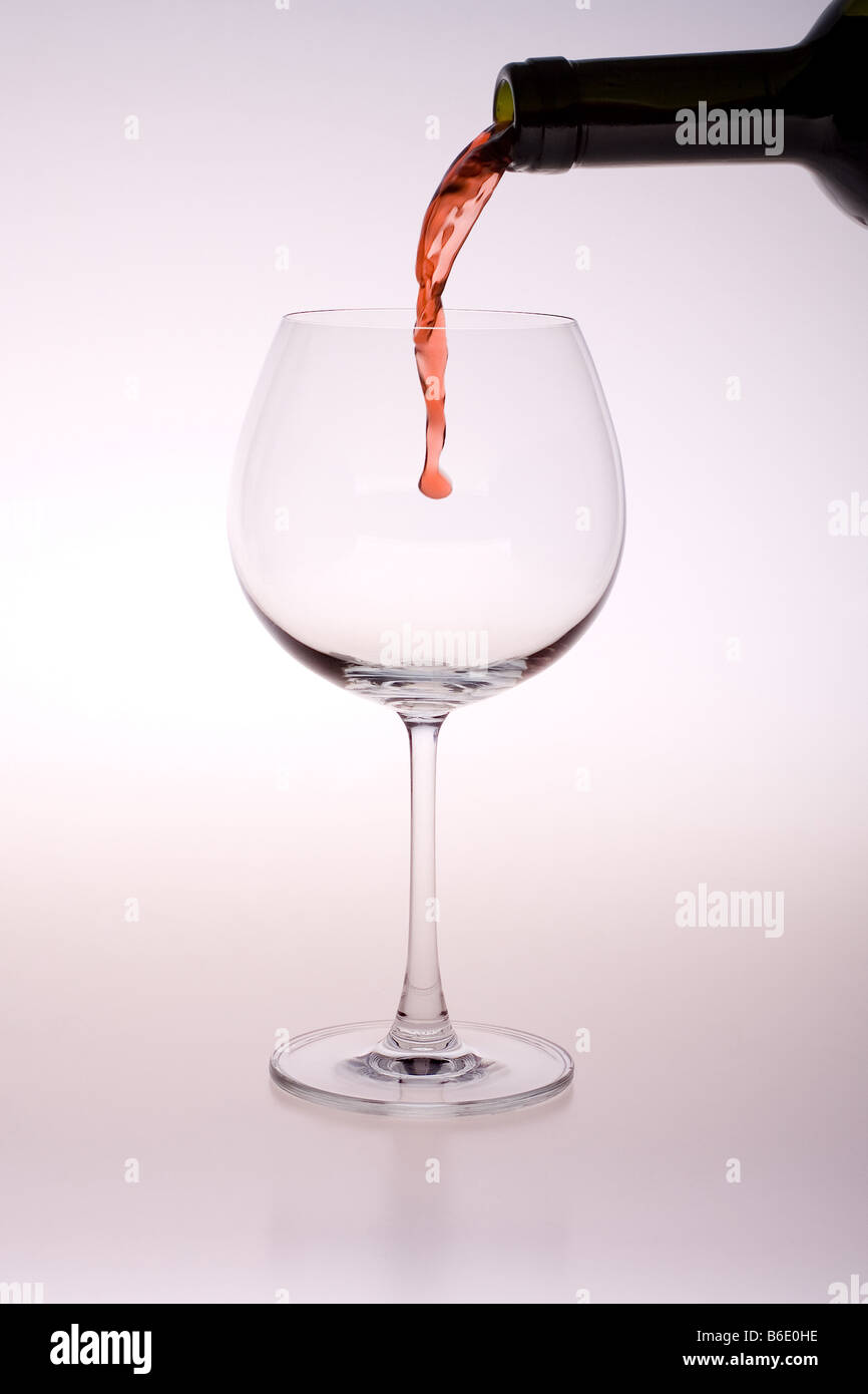 red wine flow in a transparent glass Stock Photo - Alamy
