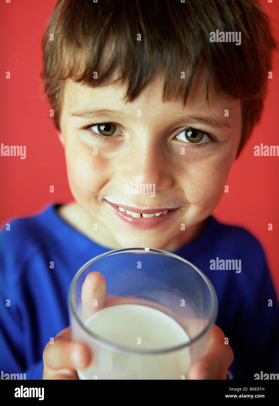 Drinking milk. 7-year-old boy with a milk moustache, after drinking a ...