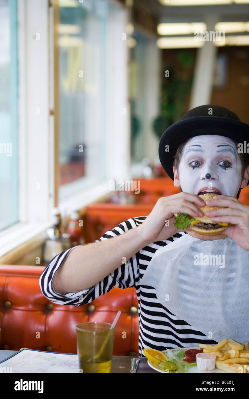 Young man, painted face, mime, smiling Stock Photo - Alamy
