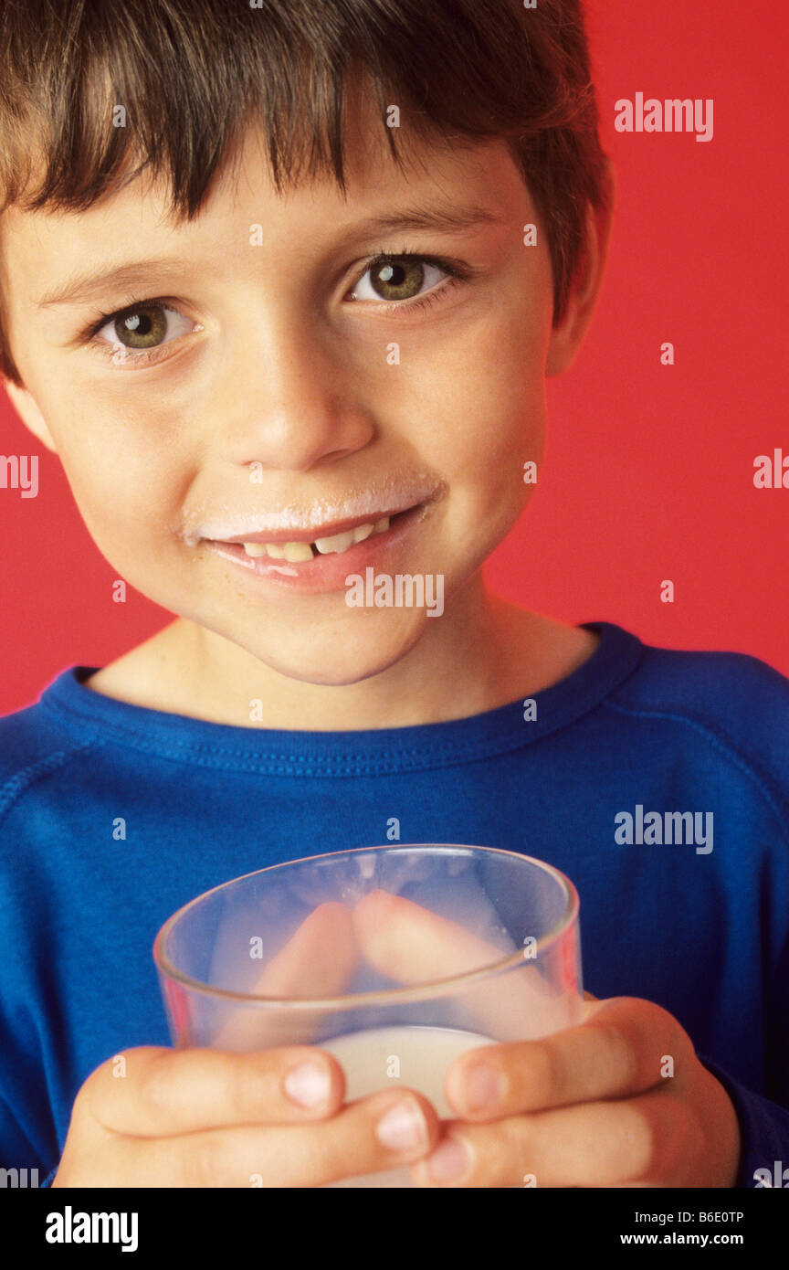 Drinking milk. 7-year-old boy with a milk moustache, after drinking a ...