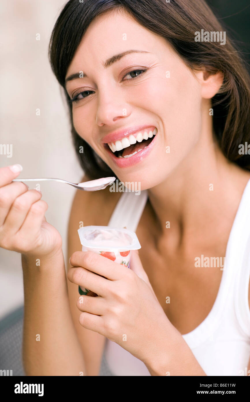Woman eating yoghurt Stock Photo - Alamy