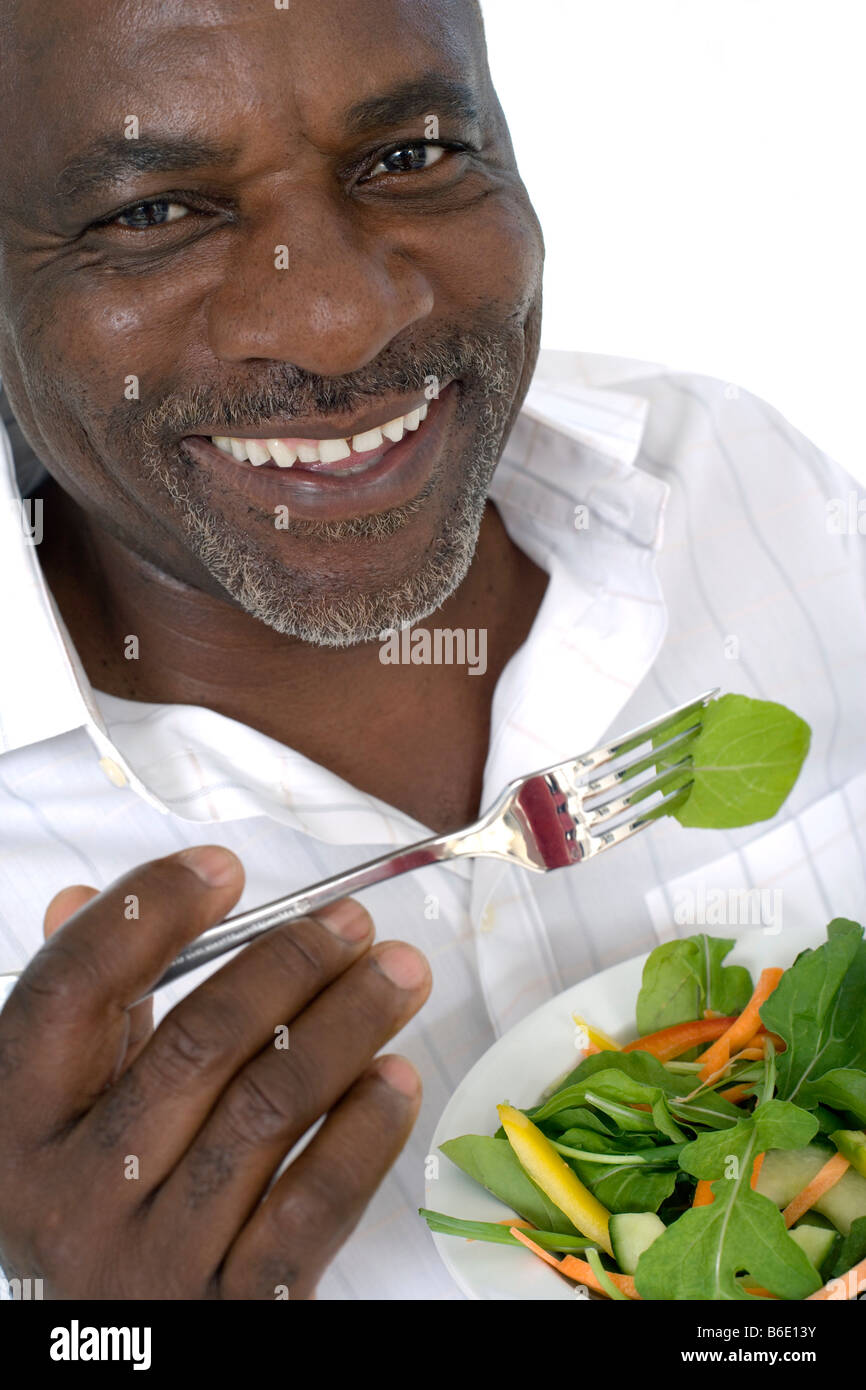Healthy eating. Man eating a salad Stock Photo - Alamy