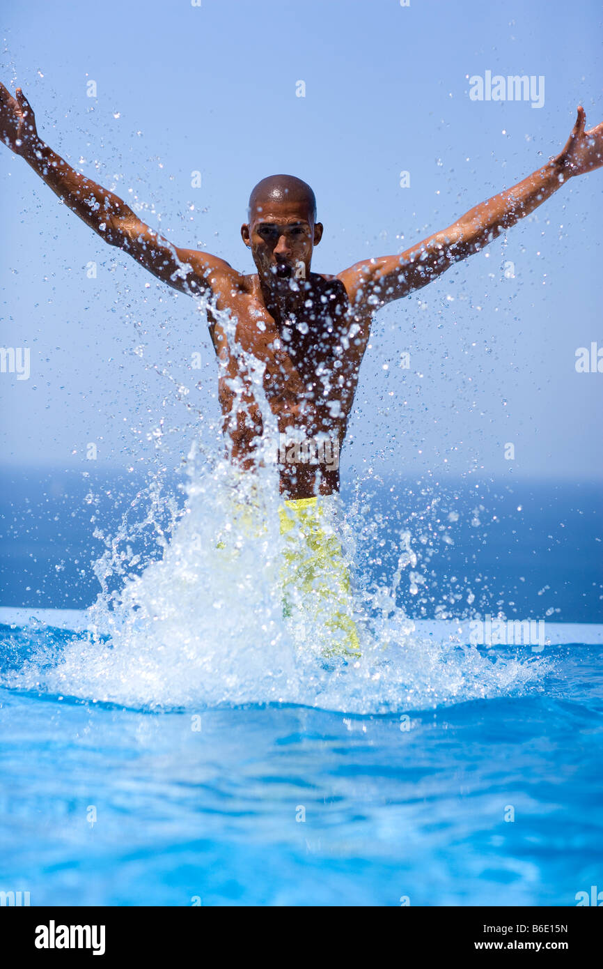 Beach holiday. Twenty year old man emerging from the ocean Stock Photo ...