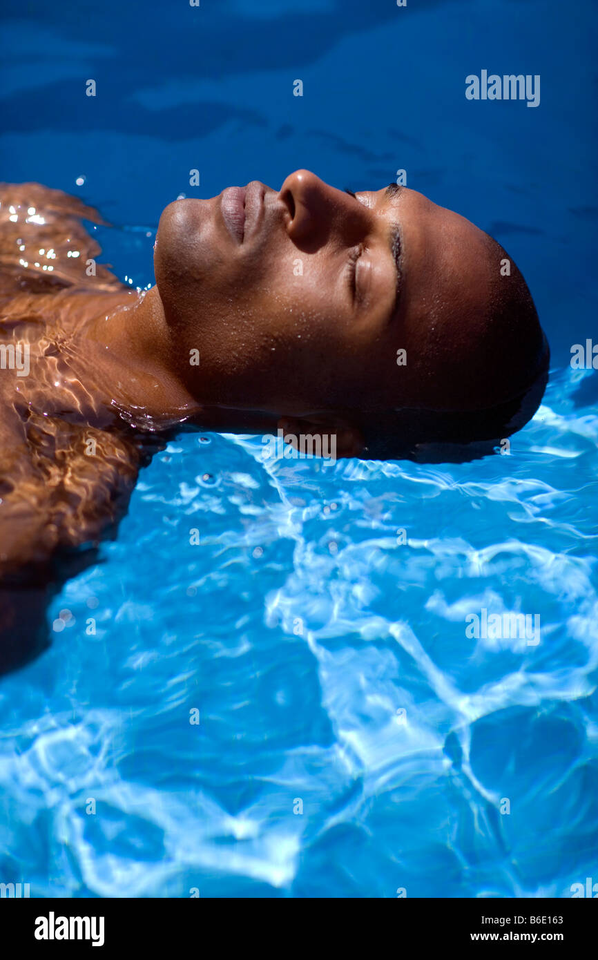Man floating in a swimming pool Stock Photo - Alamy