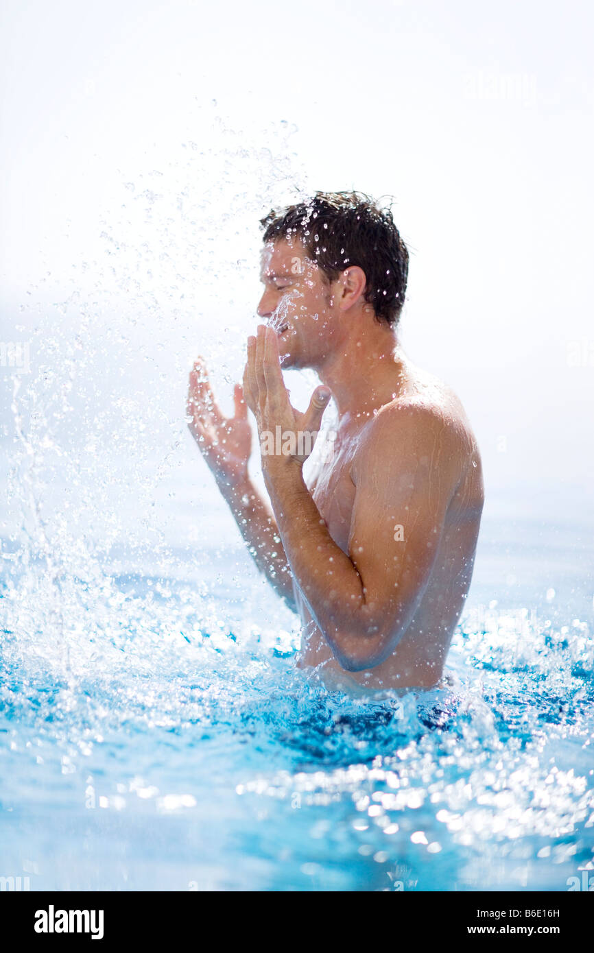 Beach holiday. Twenty-four year old man splashing in the ocean Stock ...