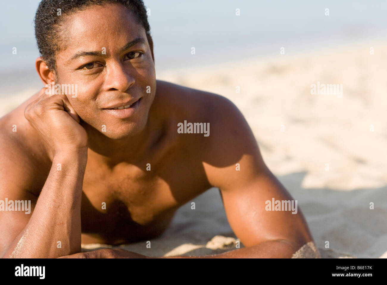 Man on a beach Stock Photo - Alamy
