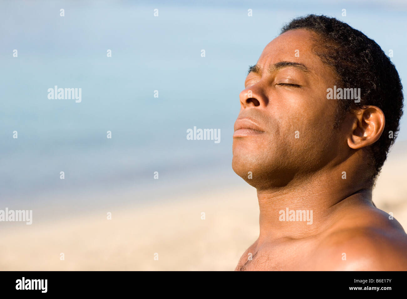 Man sunbathing on a beach Stock Photo - Alamy