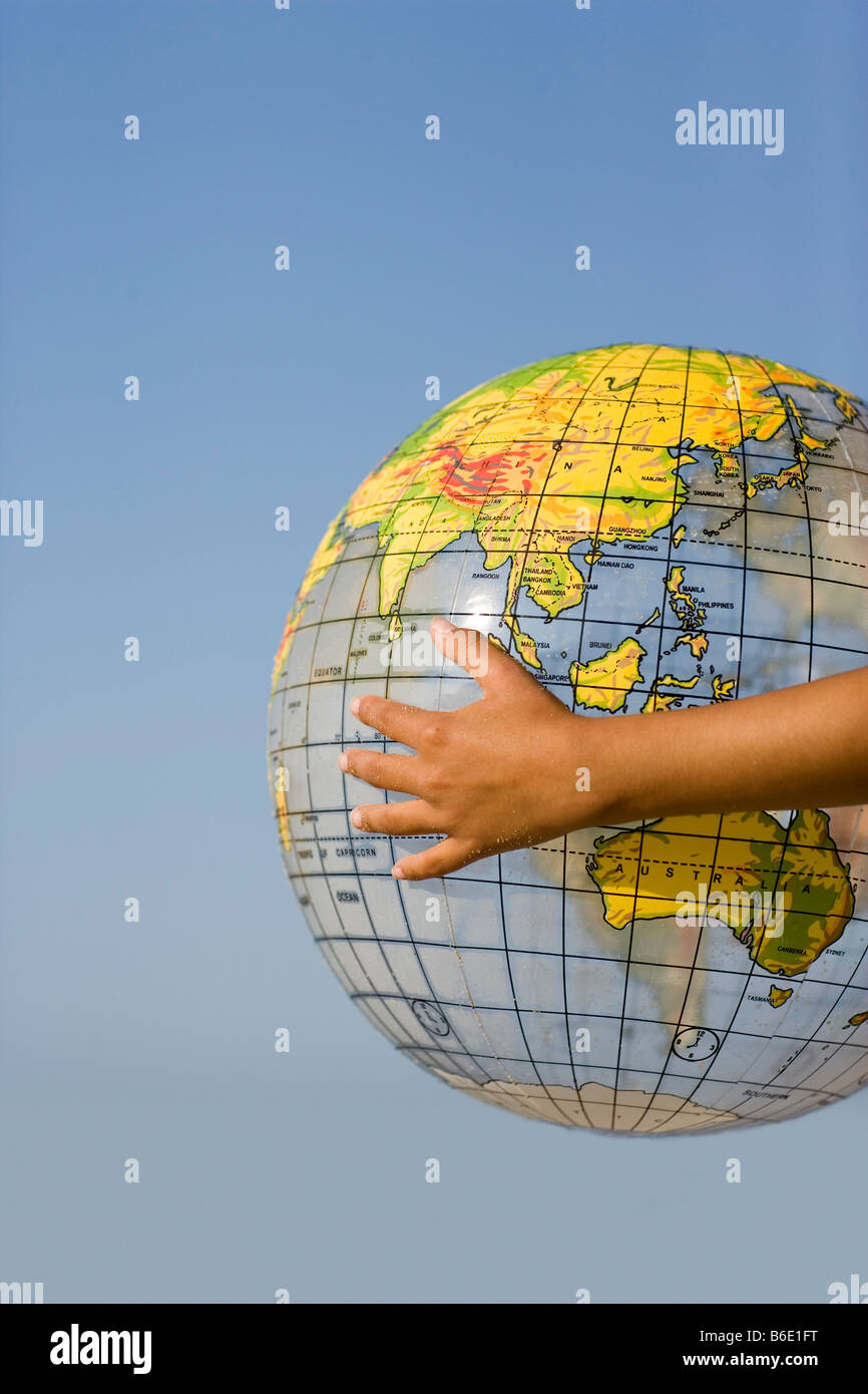 Inflated globe held by a girl Stock Photo - Alamy