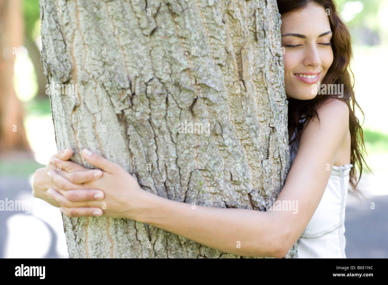 Tree hugging young woman arms hi-res stock photography and images - Alamy