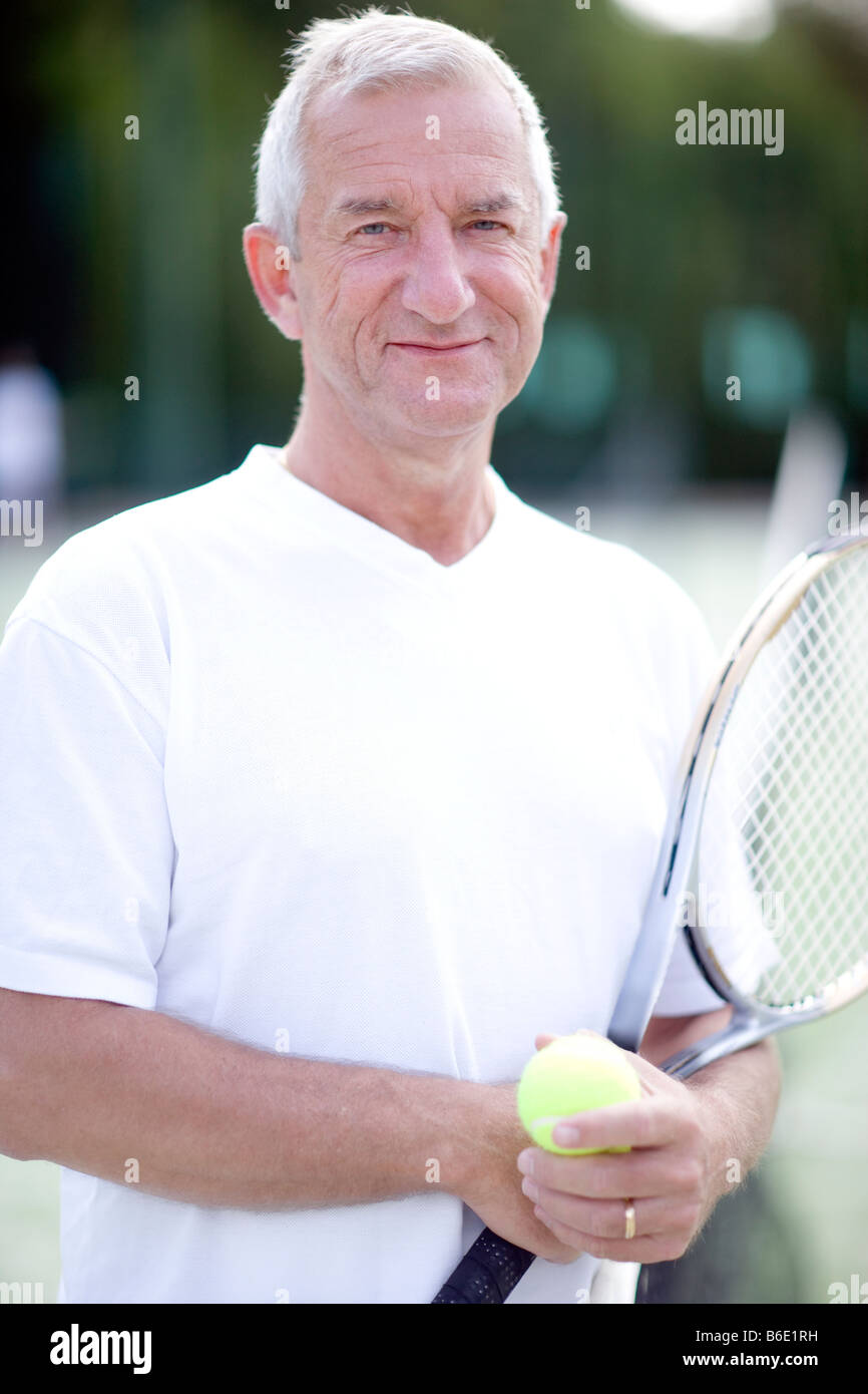 Tennis player. Man holding a tennis racquet and balls Stock Photo - Alamy