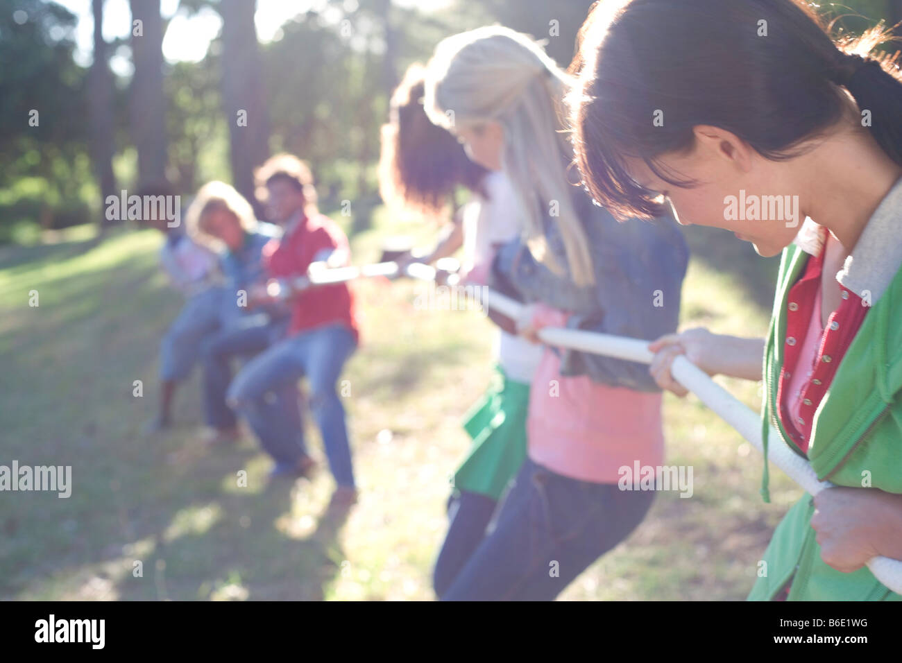 Men verses women vying for control of a rope Stock Photo - Alamy