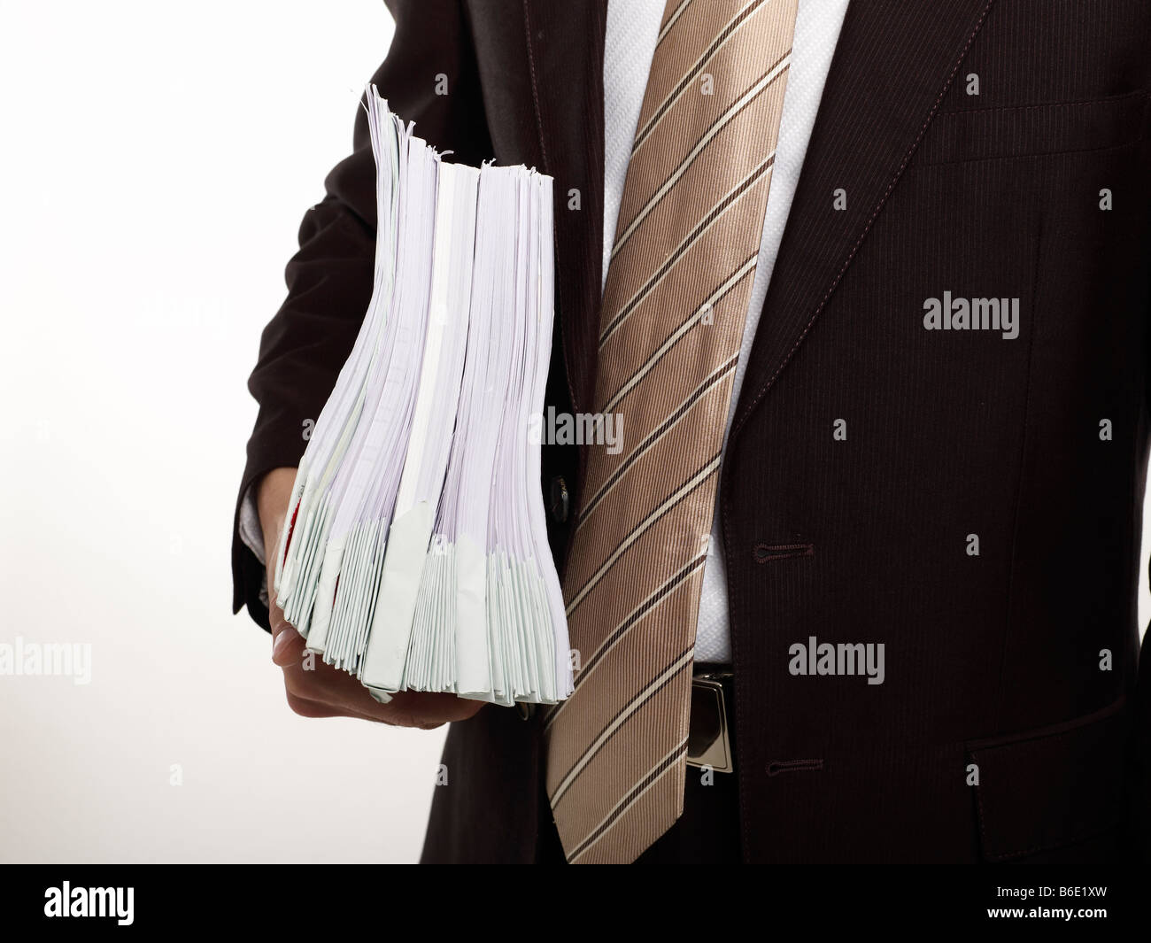 Businessman carrying paperwork Stock Photo - Alamy