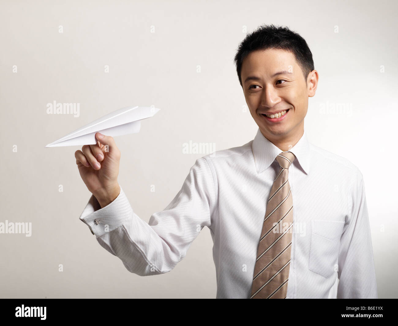 Businessman throwing paper airplane Stock Photo - Alamy