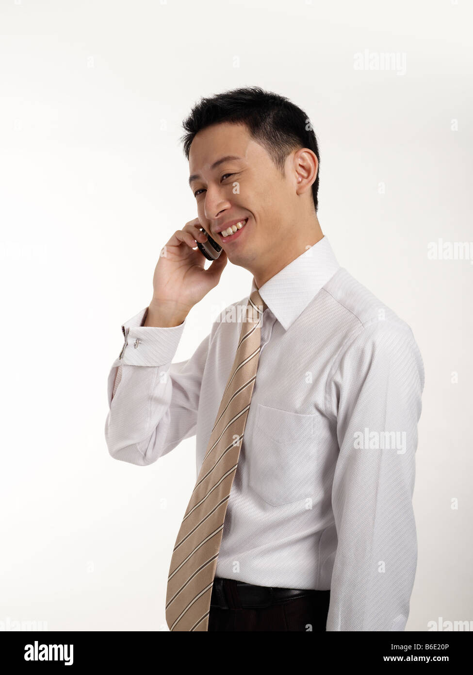 Businessman using mobile phone, smiling Stock Photo - Alamy Businessman using mobile phone, smiling Stock Photo - Alamy