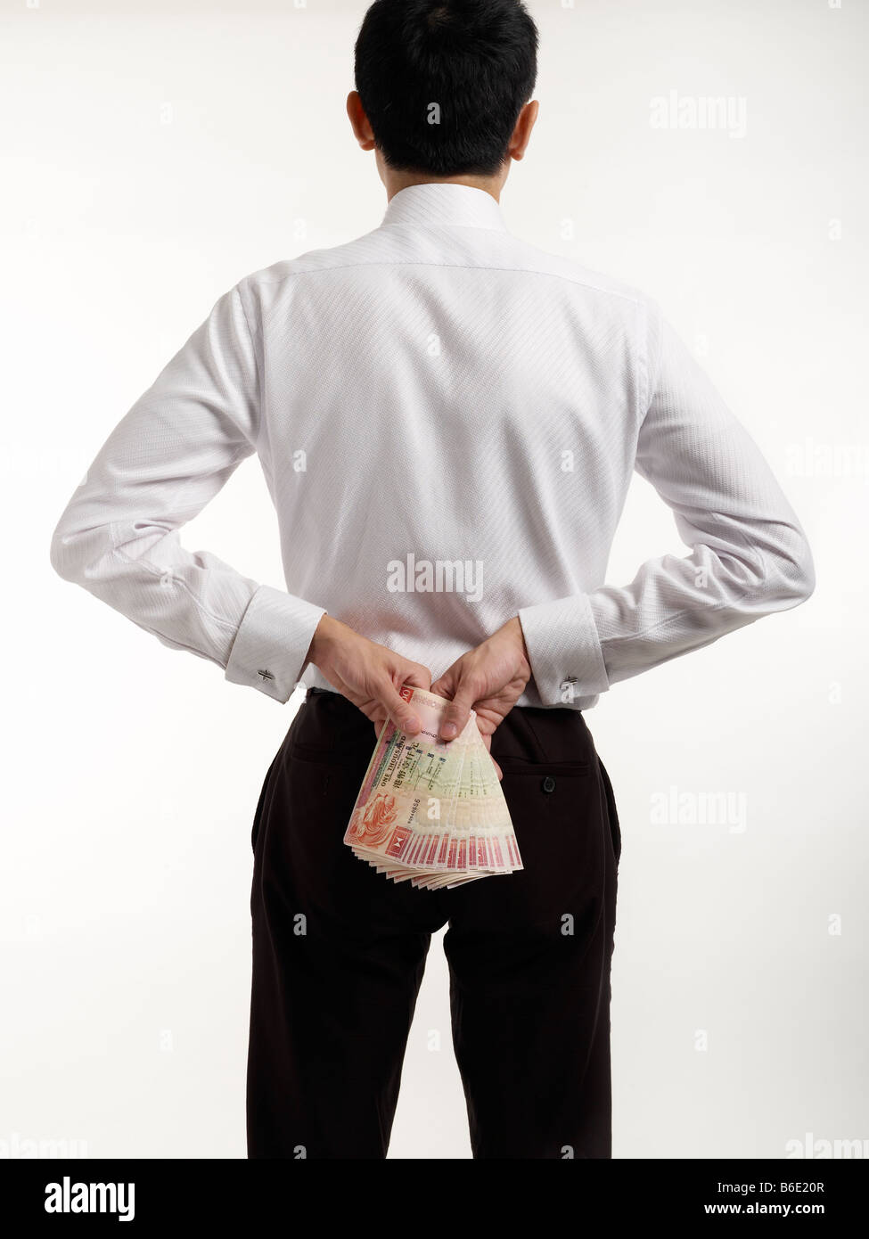 Businessman banknotes behind back, mid section Stock Photo - Alamy