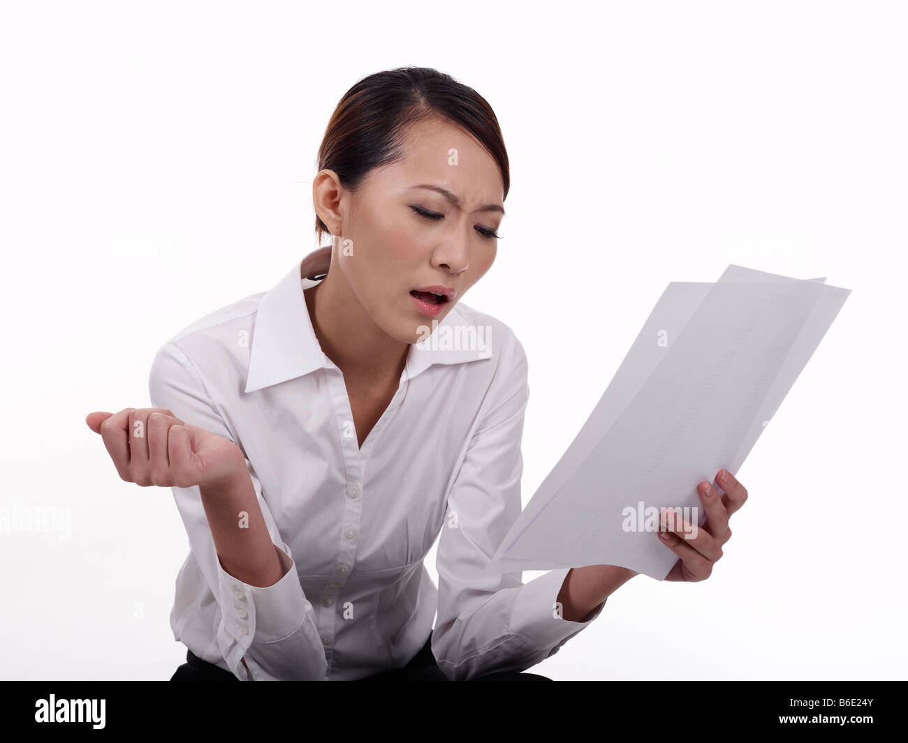 Businesswoman looking at documents Stock Photo - Alamy