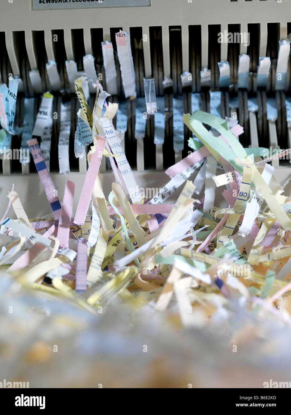 Shredded paper emerging from a shredder Stock Photo - Alamy