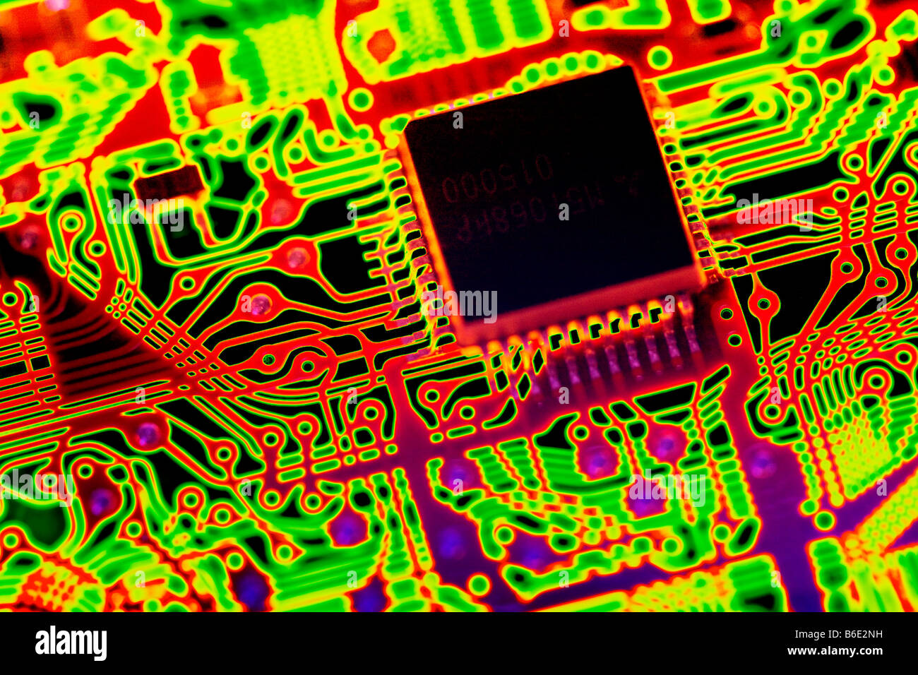 Microprocessor chip (black, upper right) in acircuit board, computer ...