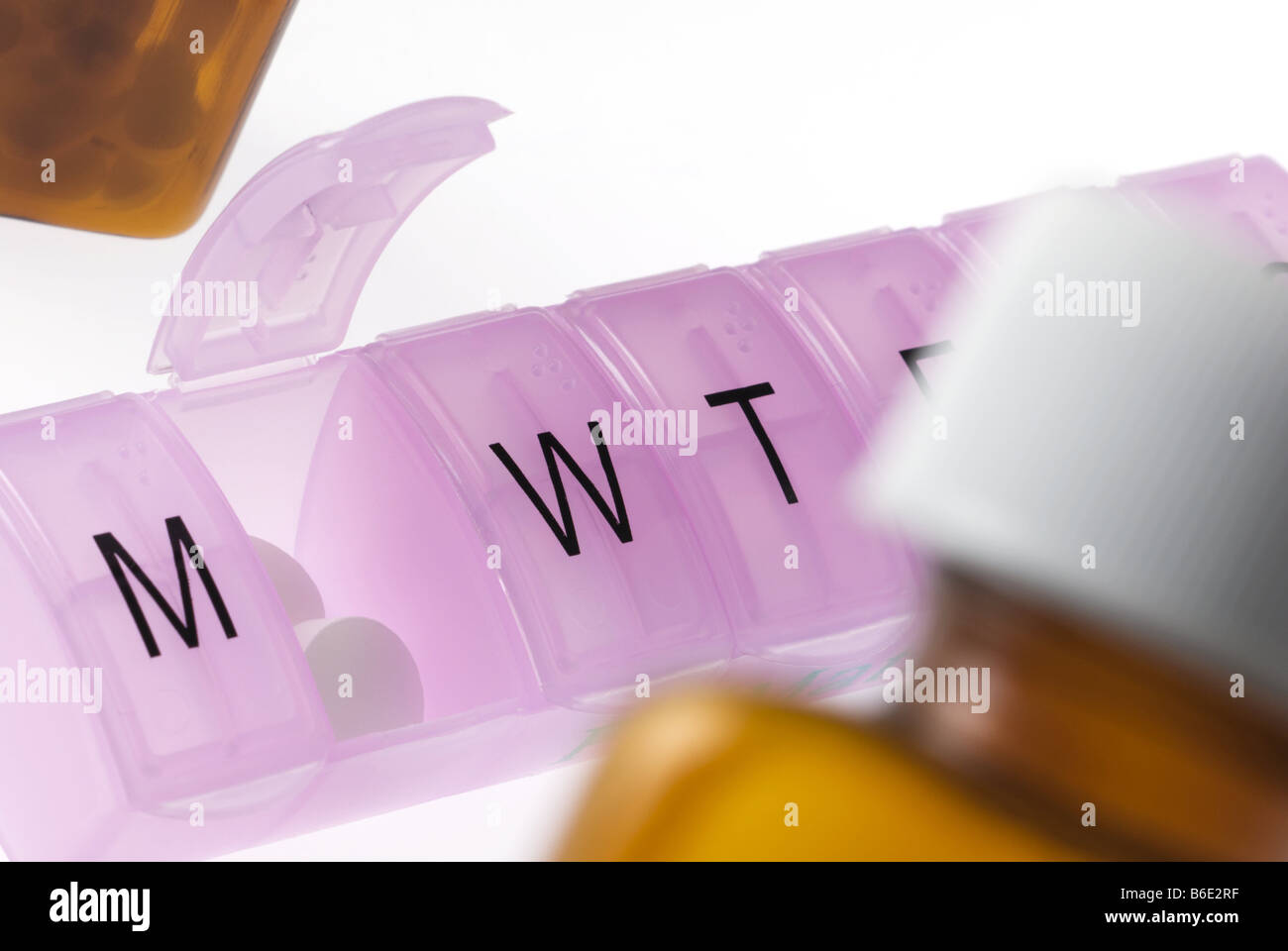 Daily pill container containing medication Stock Photo - Alamy