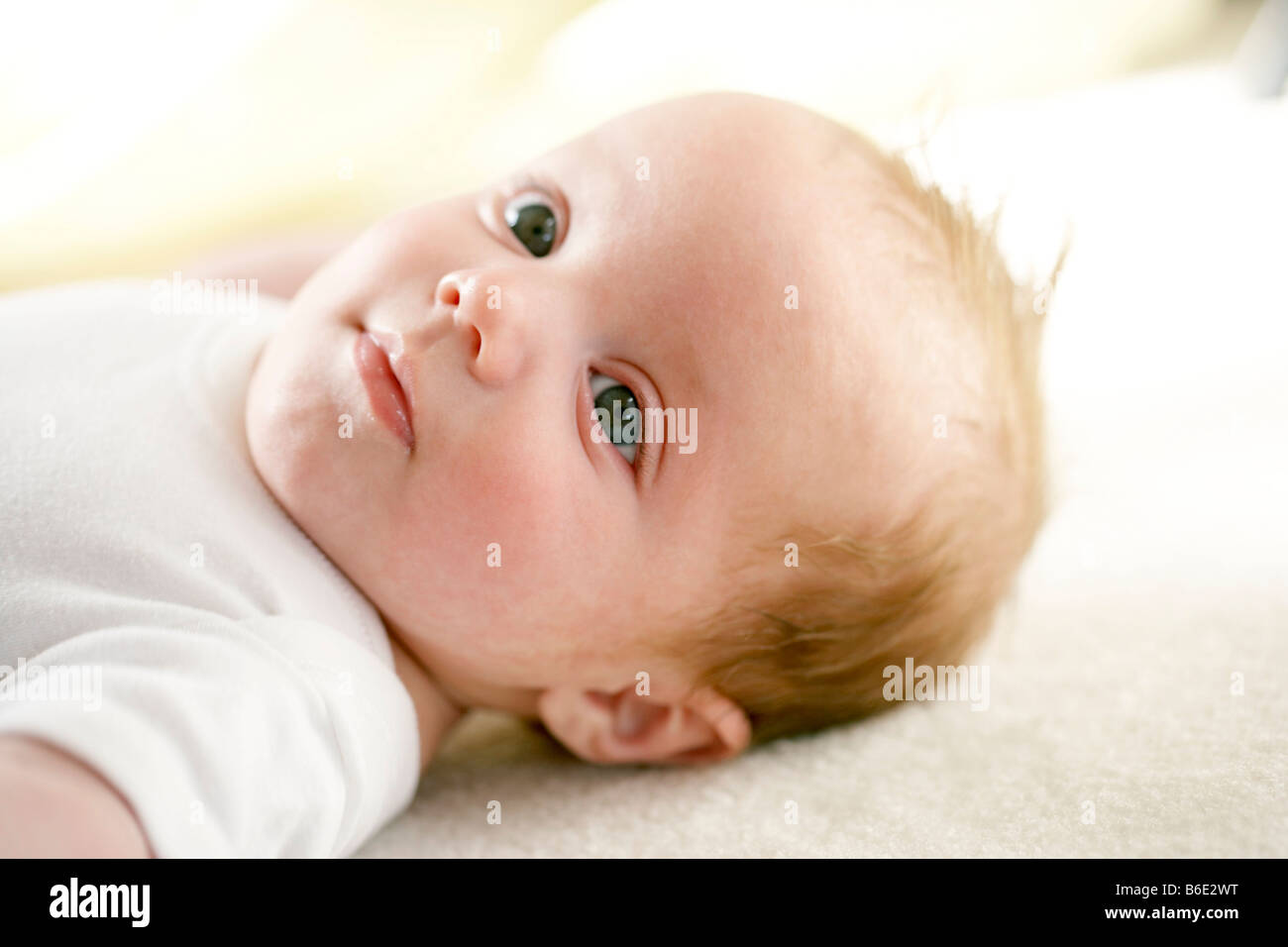 Baby girl lying on her back Stock Photo - Alamy
