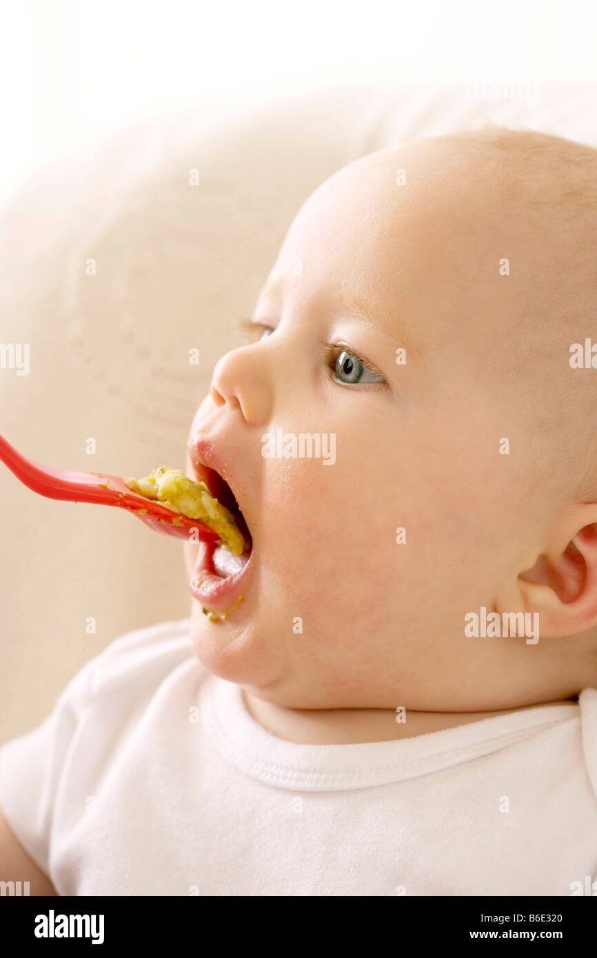 Baby girl being spoon-fed Stock Photo - Alamy