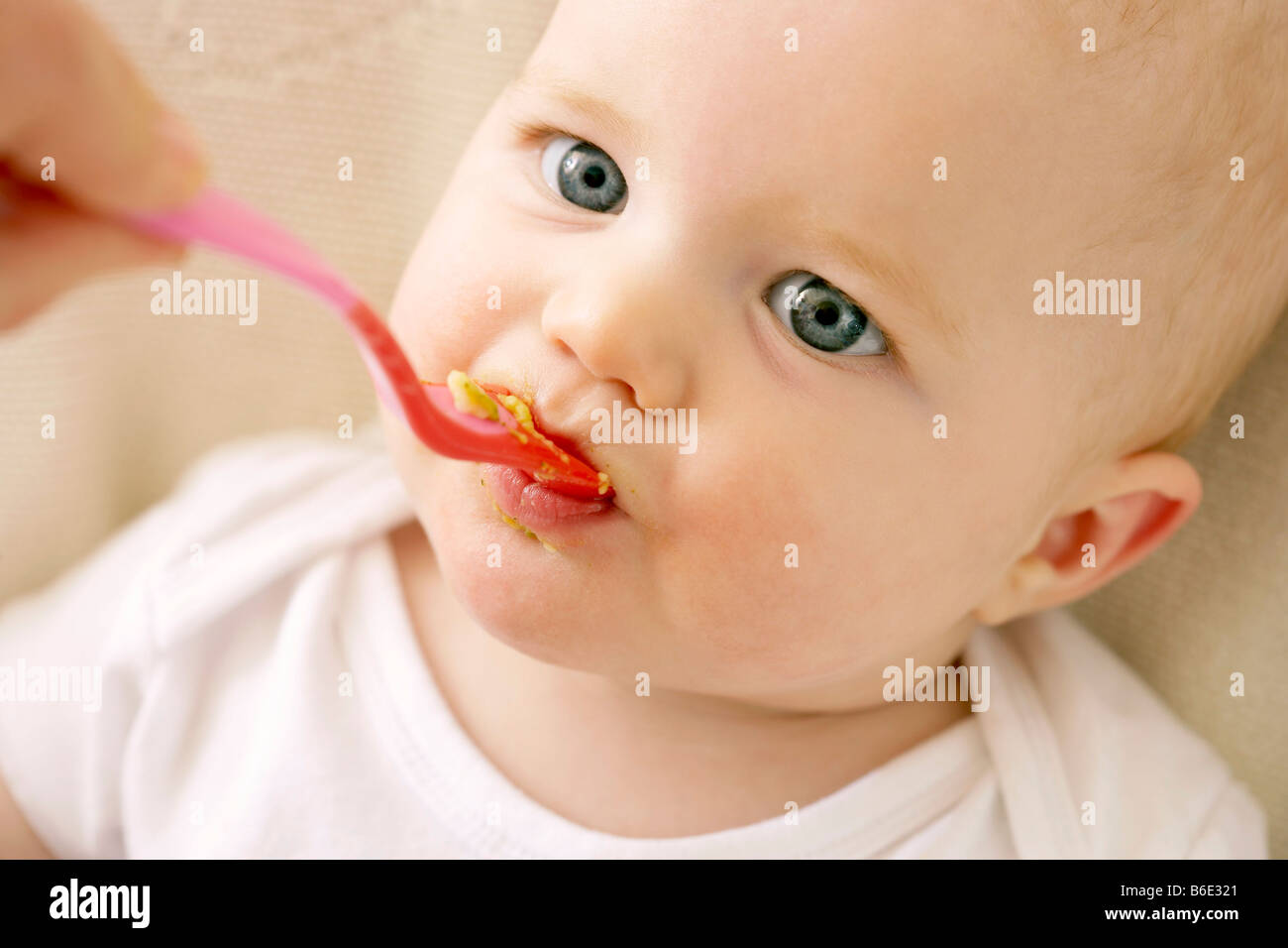 Baby girl being spoon-fed Stock Photo - Alamy