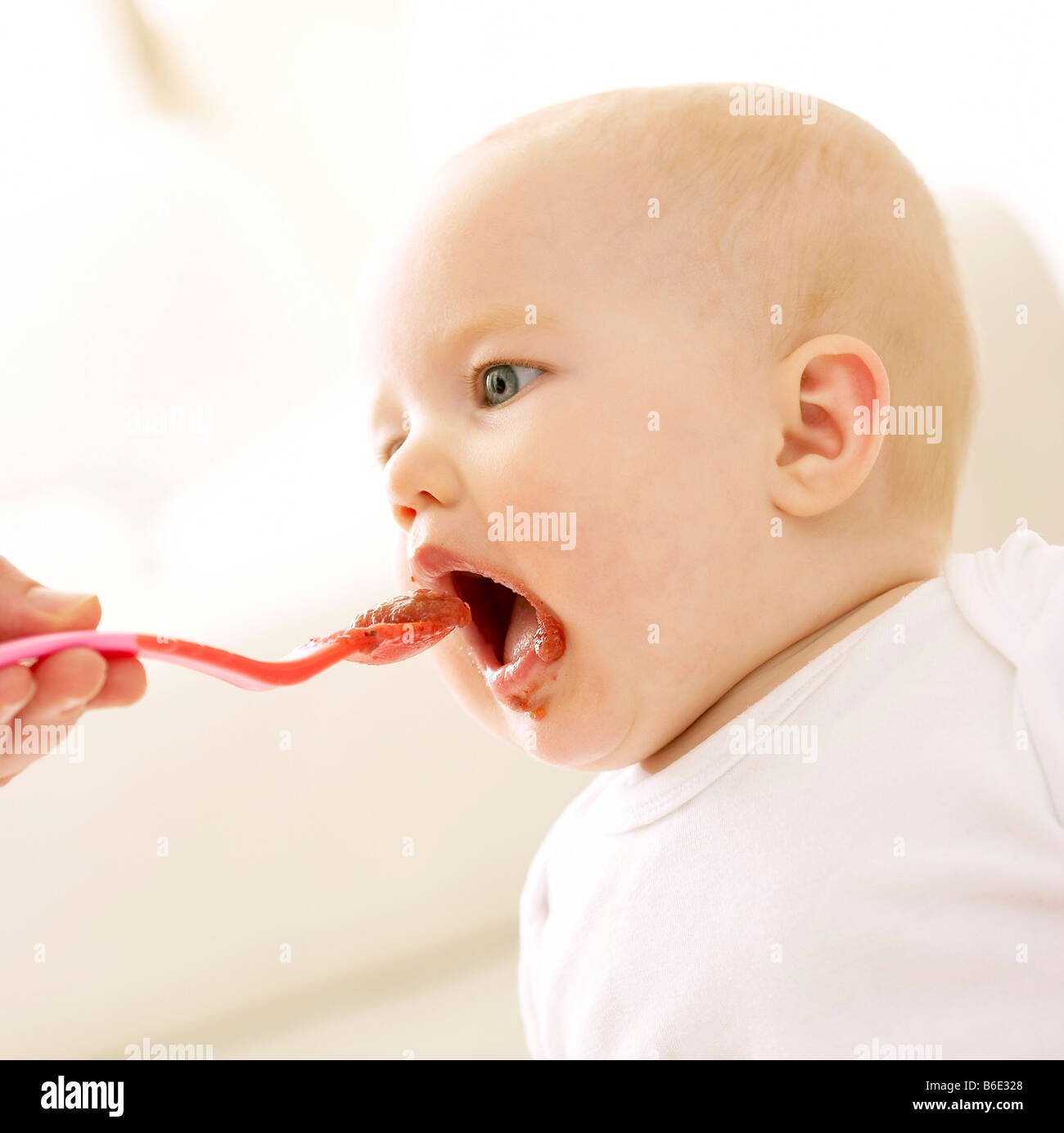Mother feeding her baby, side view Stock Photo - Alamy