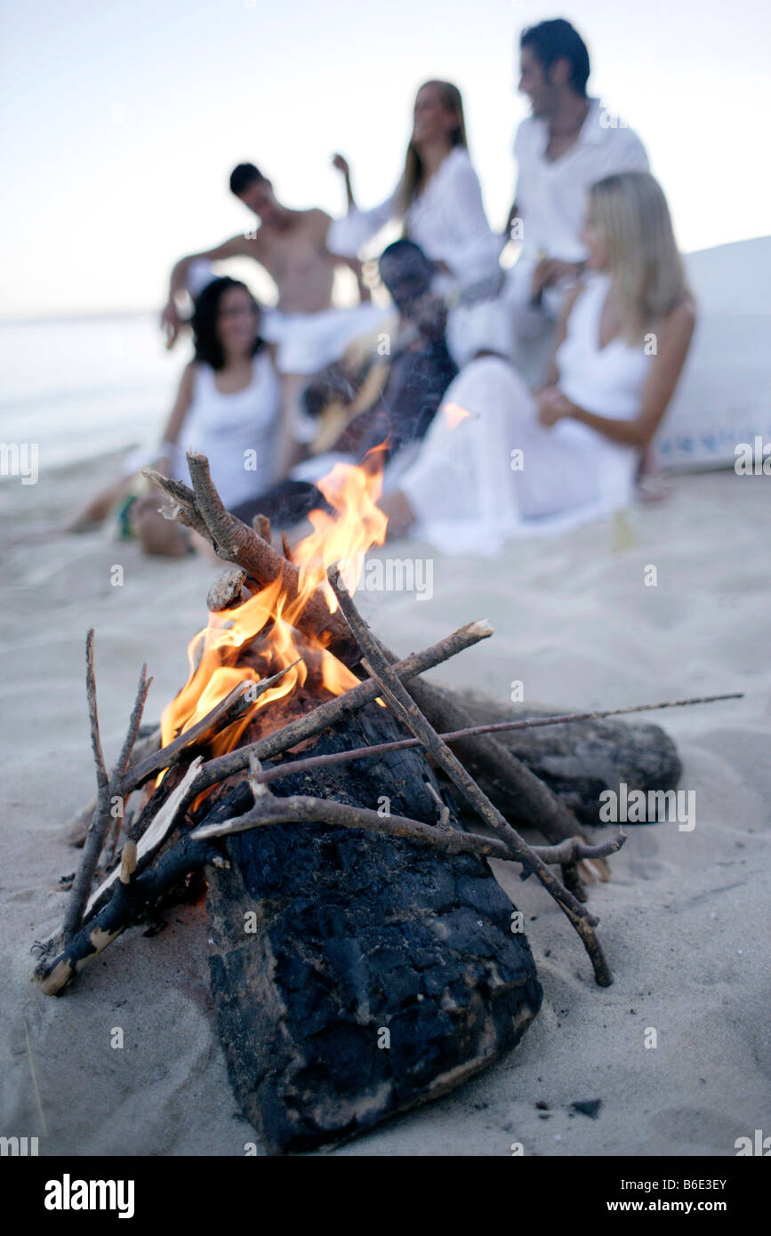 Young friends with bonfire in foreground Stock Photo - Alamy