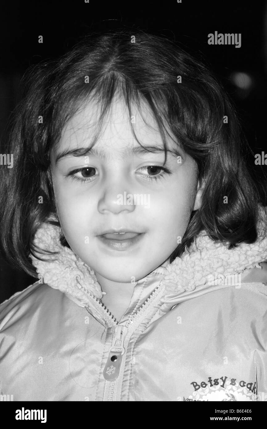 Little girl (toddler) looking down through the camera. Close up, head ...