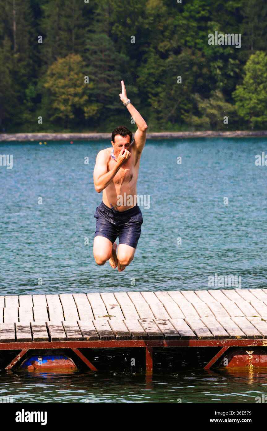man jumping into lake Stock Photo - Alamy