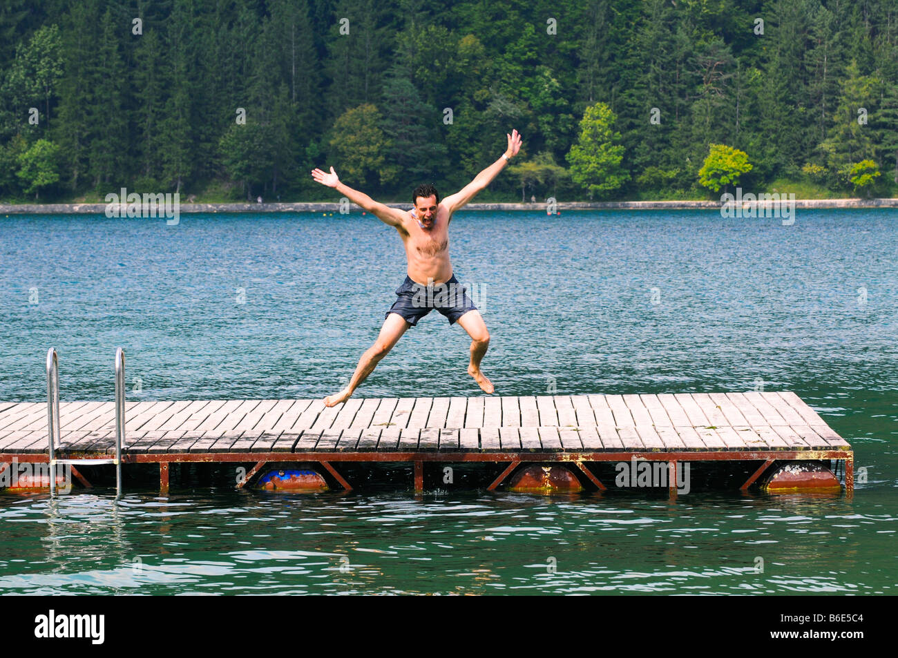man jumping into lake Stock Photo - Alamy