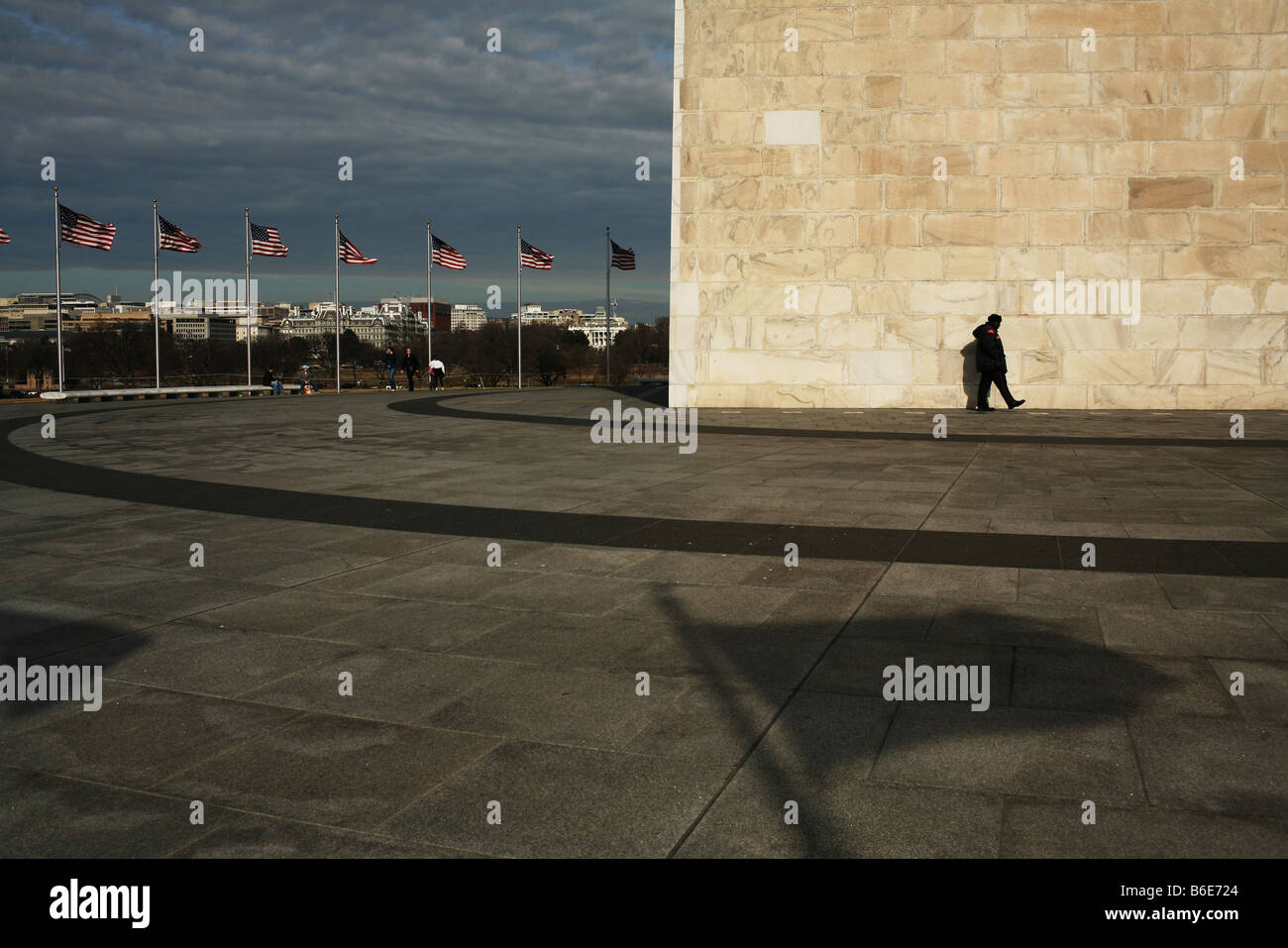 A security guard walks by the Washington Monument in Washington DC on ...