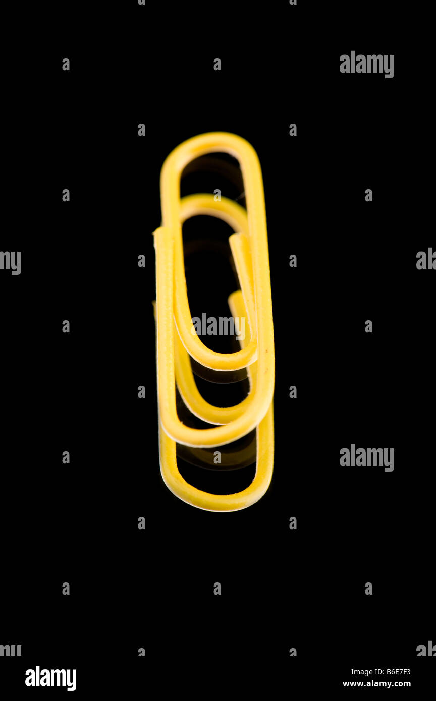 object on black office tool paper clip on black Stock Photo - Alamy