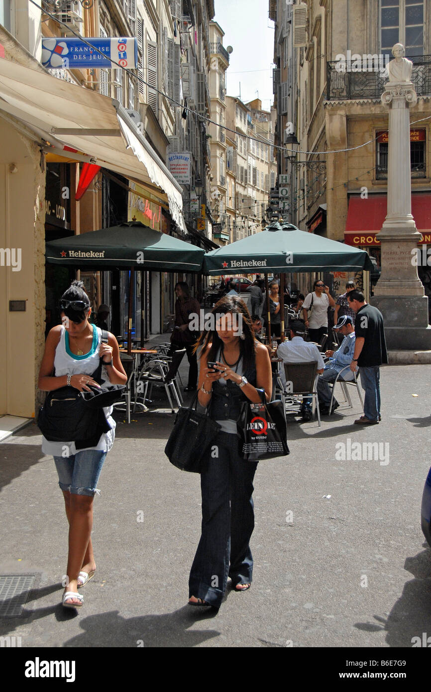 Two young women passing a restaurant in the historic city centre of ...
