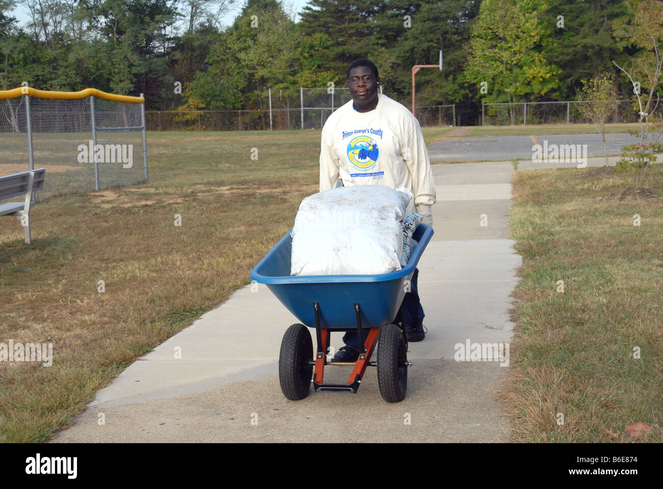 Teen with a full wheelbarrow Stock Photo - Alamy