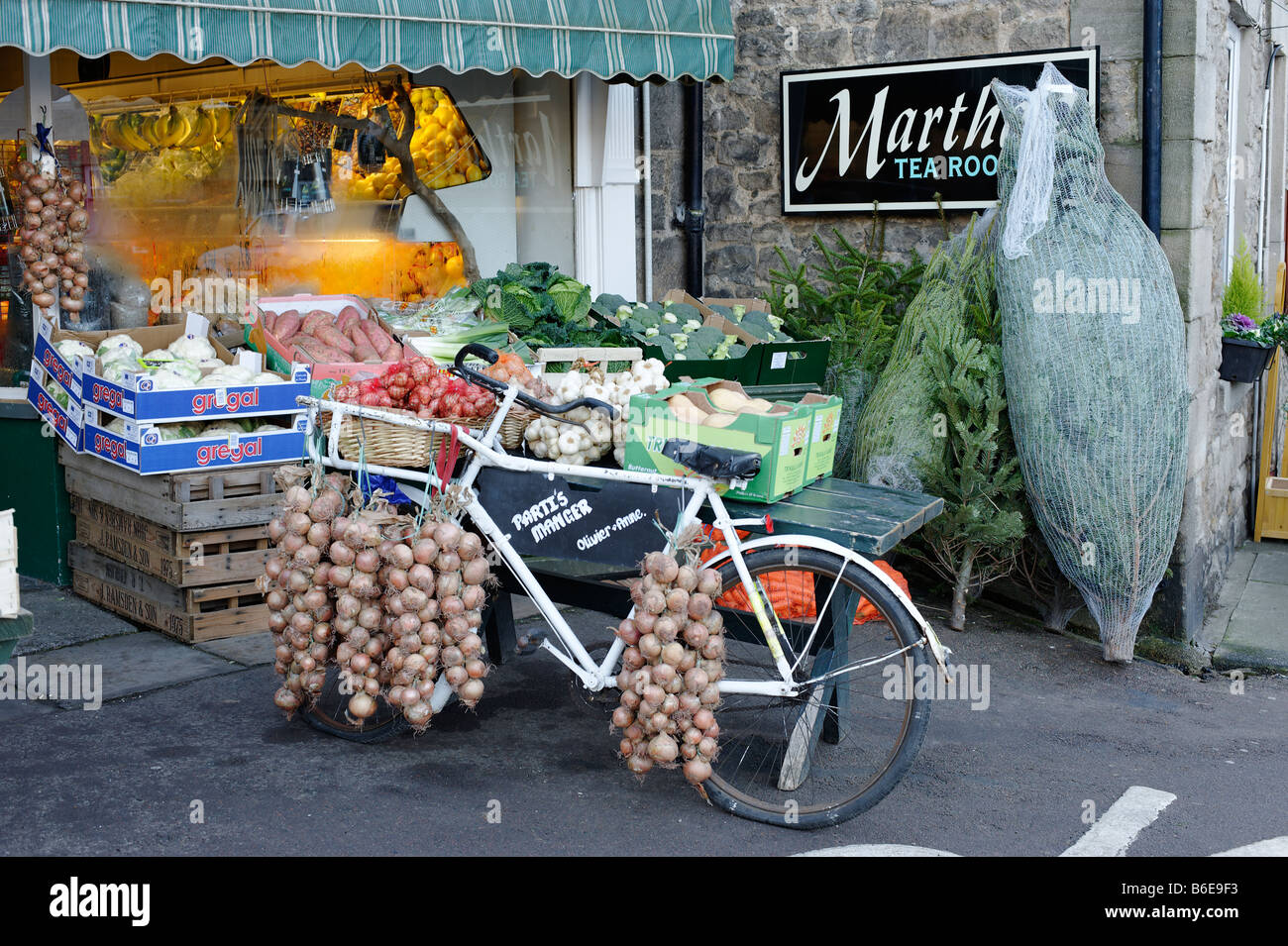 Grocer shop front with produce on display on pavement scene including ...