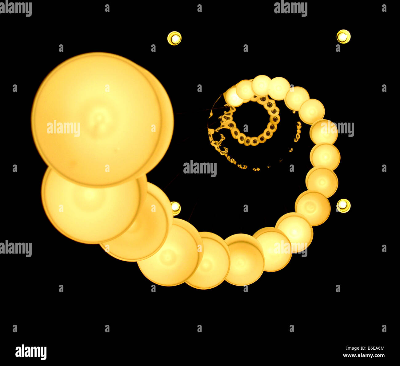 little yellow lights spiraling on black background Stock Photo - Alamy