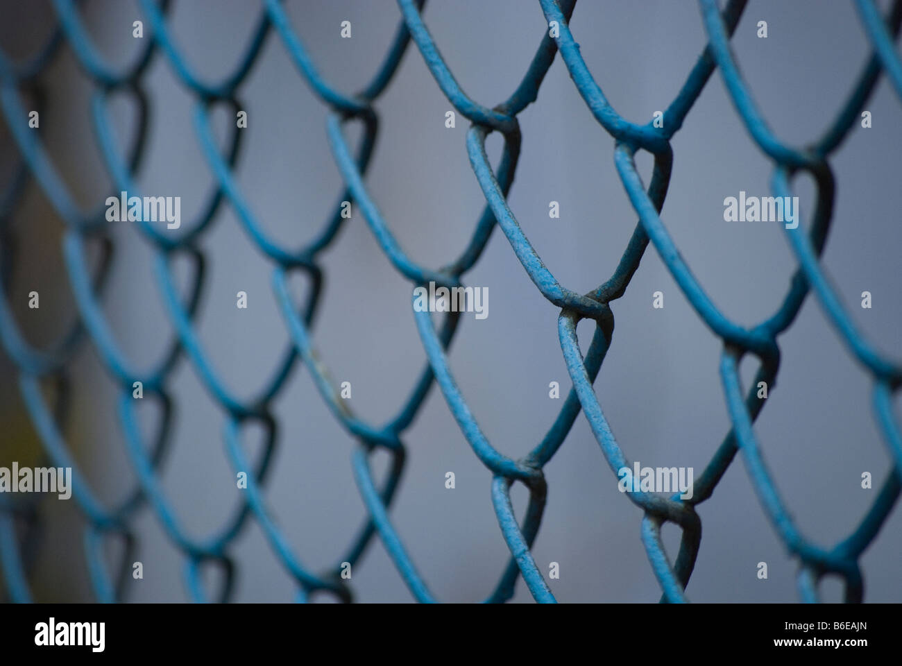 Blue chain link wire fence Stock Photo - Alamy