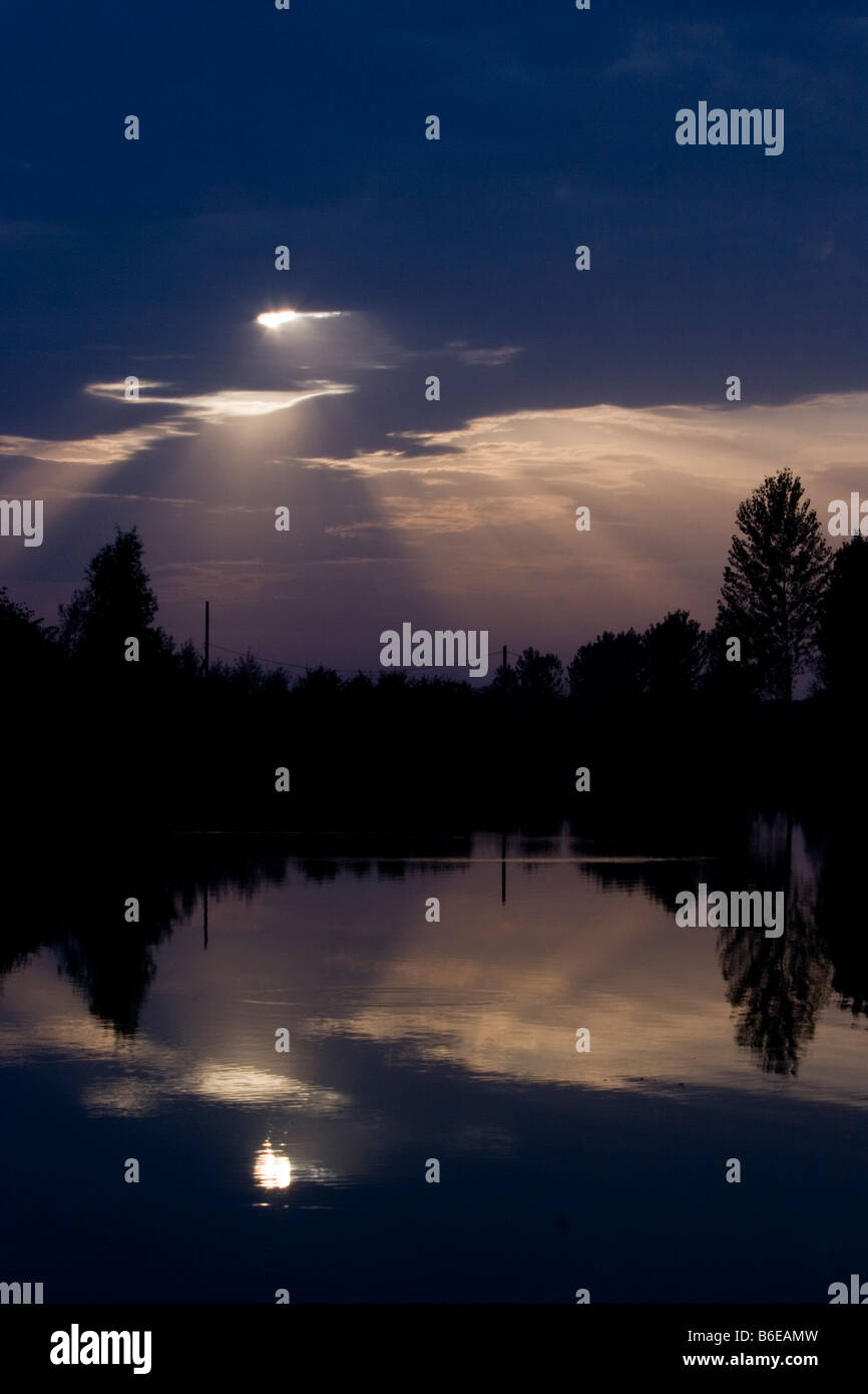 sunlight falling through clouds on a sea Stock Photo - Alamy