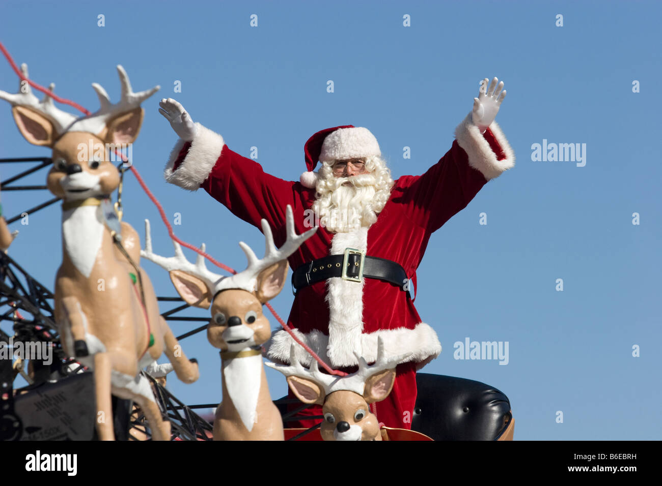 Santa Clause waves to the crowd during a parade Stock Photo - Alamy