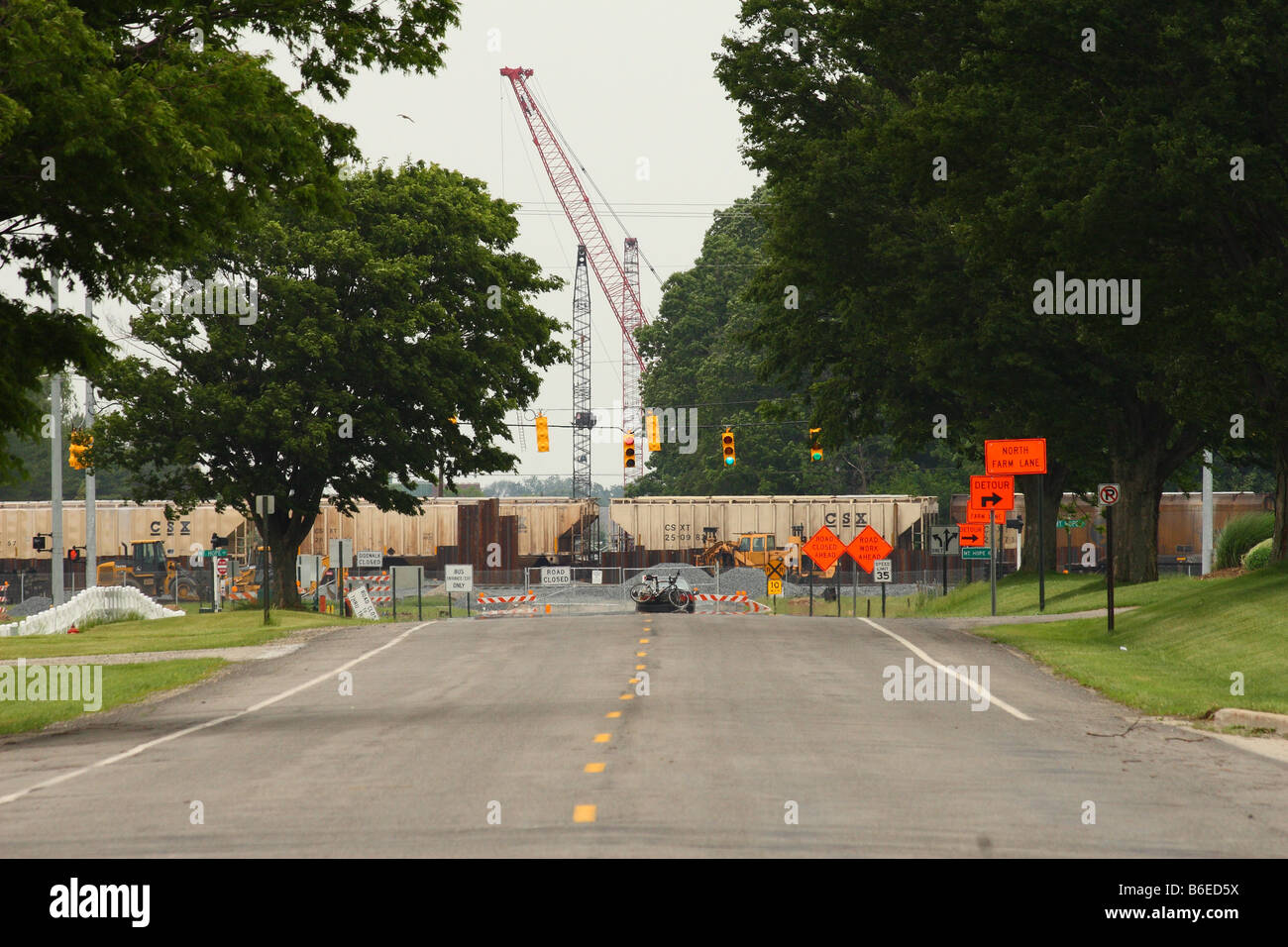 A freight train passes through a construction zone where a rail grade ...