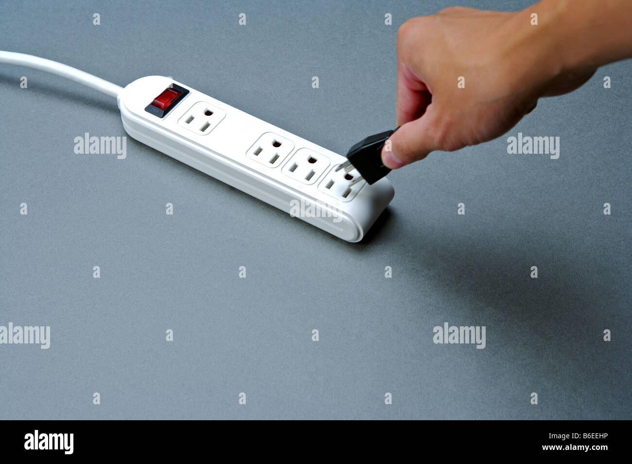 Hand plugging a plug into an electricity outlet Stock Photo - Alamy