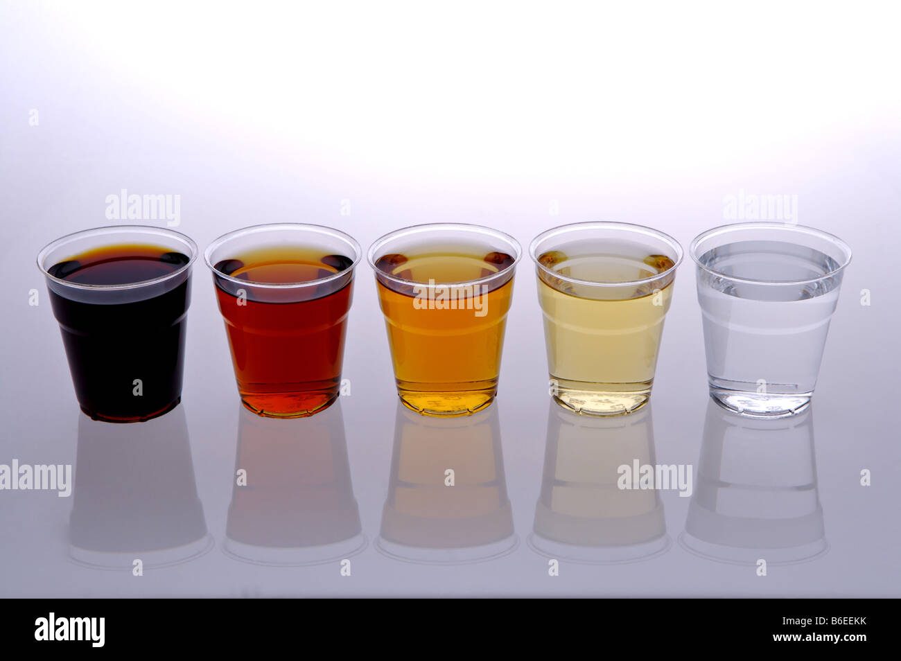 Plastic cups filled with liquid in a row Stock Photo - Alamy