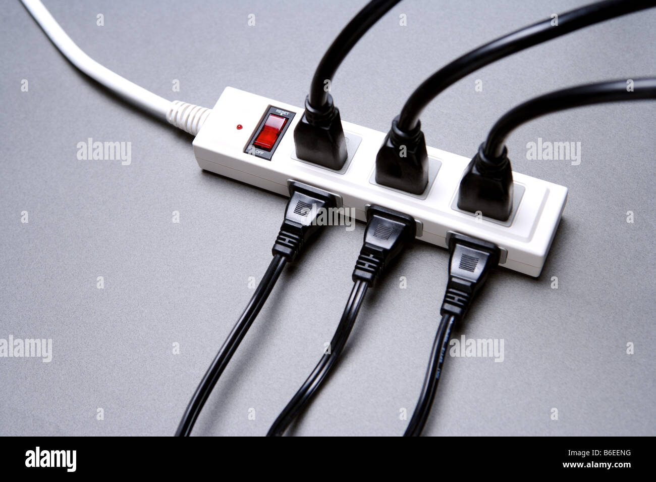 Electricity outlet filled with plugs Stock Photo - Alamy