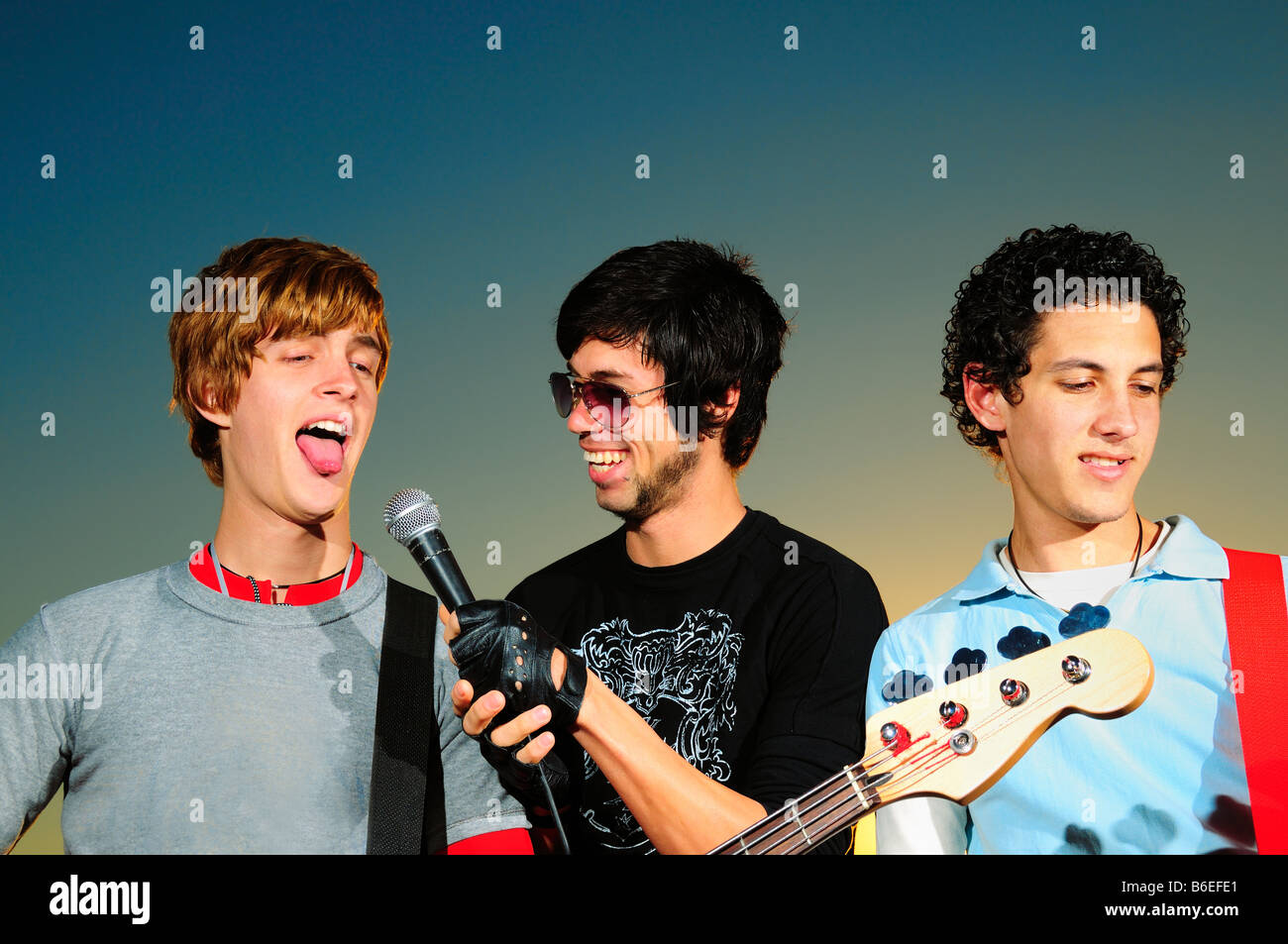 Portrait of three young musicians playing and singing together Stock ...